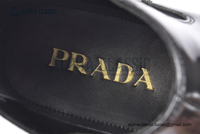Prada Classic Patent Black Calfskin Boot with the Iconic Enameled Metal ...